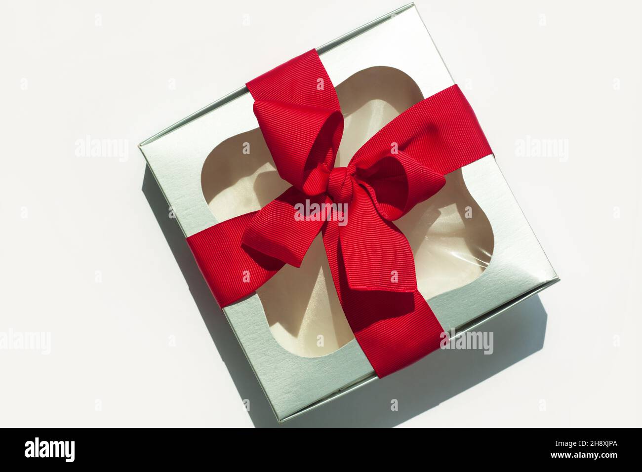 Silver gift box with red ribbon bow isolated on white background ...