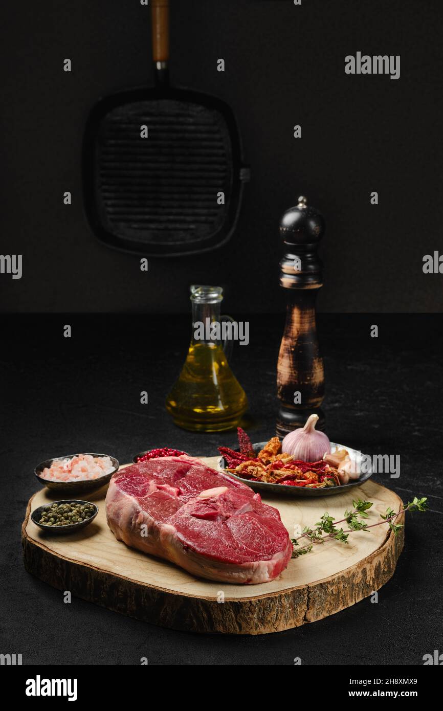 Raw fresh lamb center cut leg steak with spice on the kitchen table ...