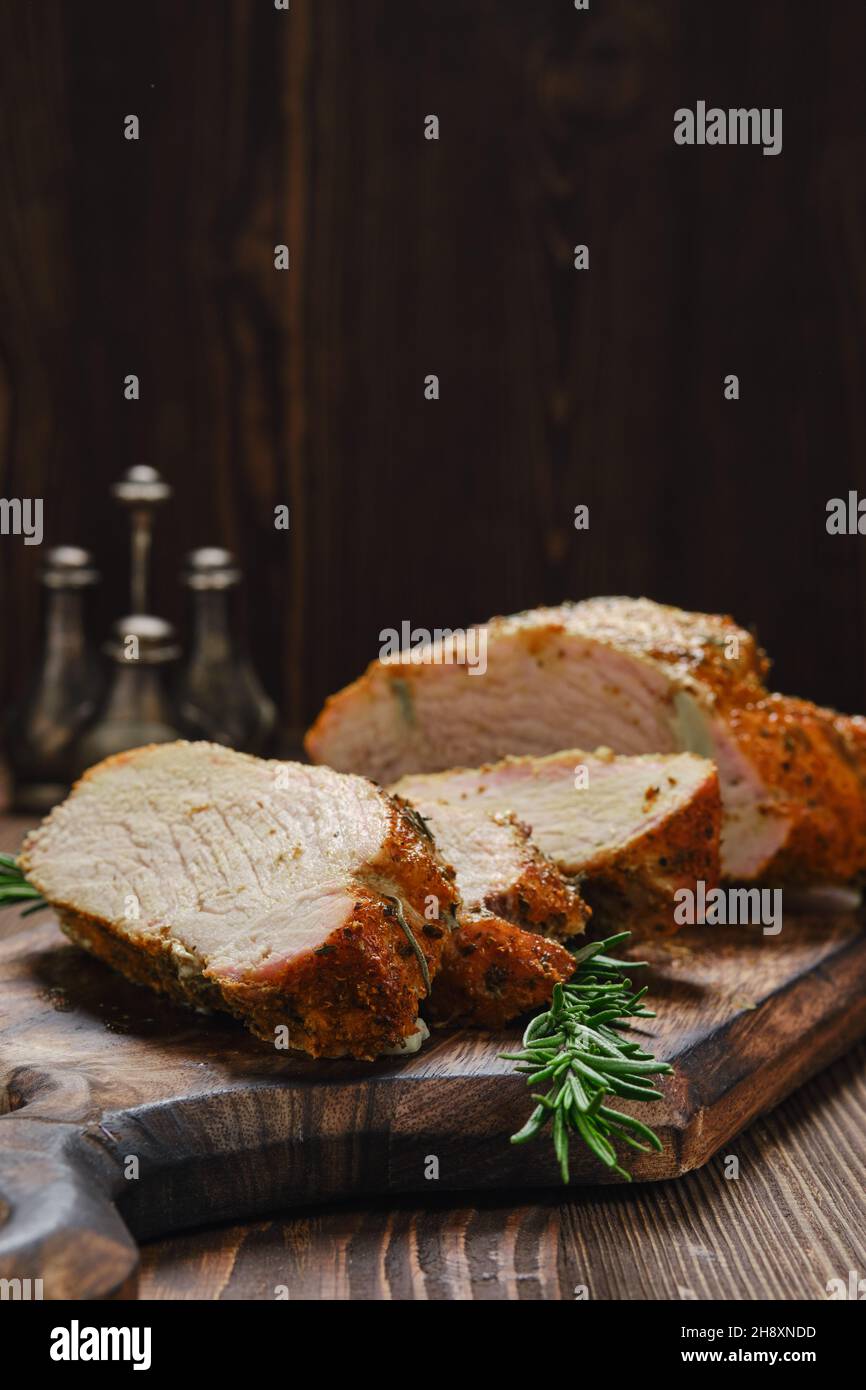 Closeup view of pork collar joint baked in oven on wooden cutting board ...