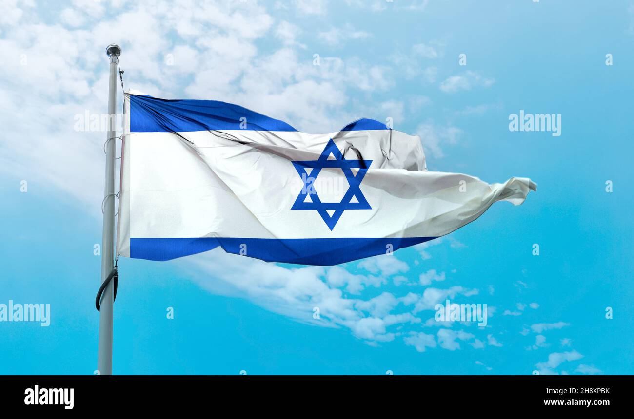 Israeli flag waving on a pole in a blue sky Stock Photo - Alamy