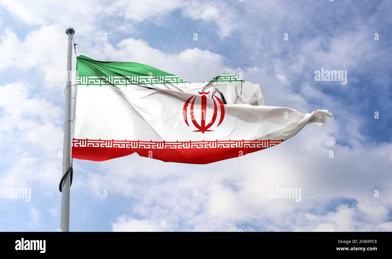 Iran flag waving on a pole in a blue sky Stock Photo - Alamy