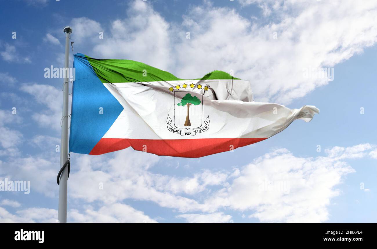 Equatorial Guinea flag waving on a pole in a blue sky Stock Photo - Alamy