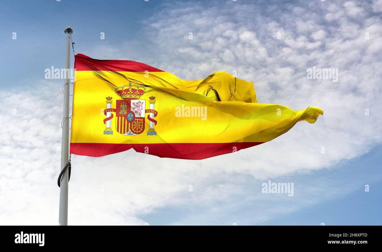 Spanish flag waving on a pole in a blue sky Stock Photo - Alamy