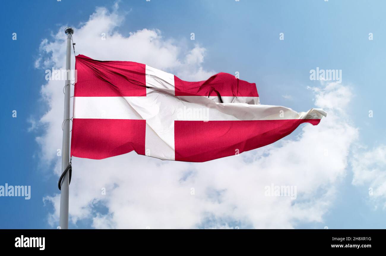 Denmark flag waving on a pole in a blue sky Stock Photo - Alamy