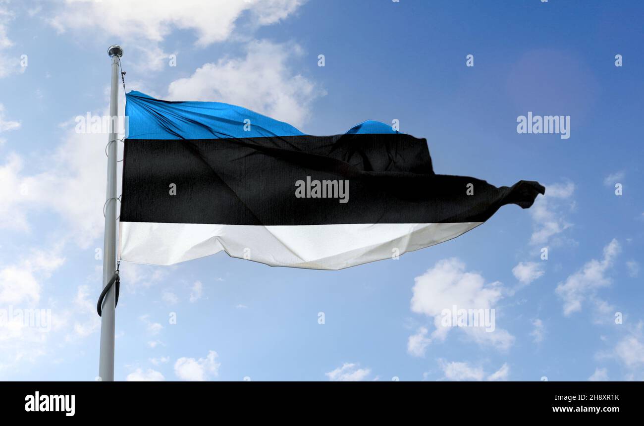 Estonian flag waving on a pole in a blue sky Stock Photo - Alamy