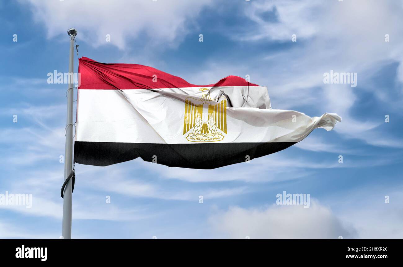 Egyptian flag waving on a pole in a blue sky Stock Photo - Alamy