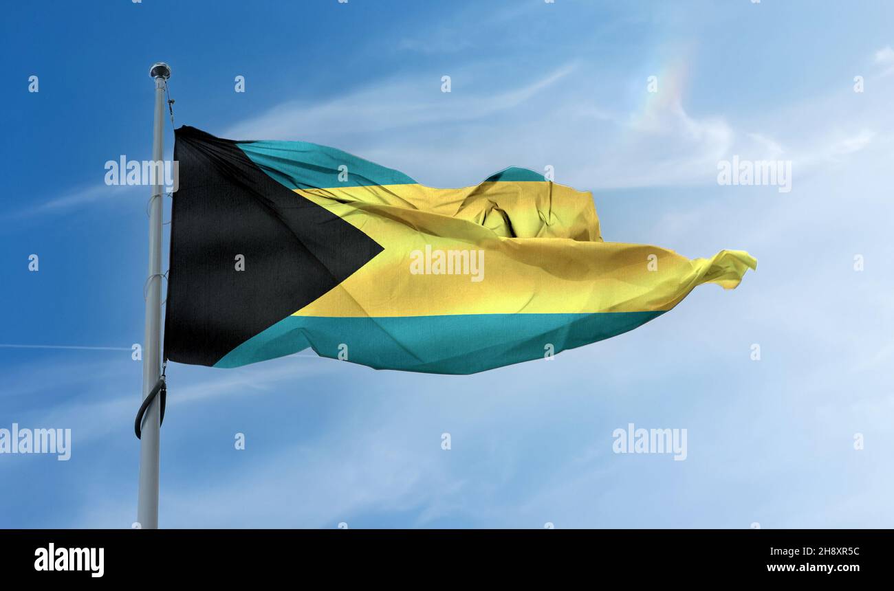 Bahamas flag waving on a pole in a blue sky Stock Photo - Alamy