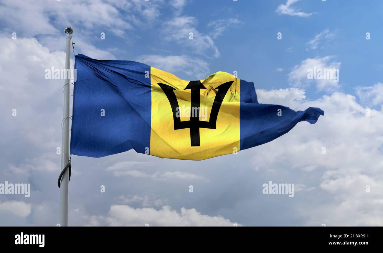 Barbados flag waving on a pole in a blue sky Stock Photo - Alamy