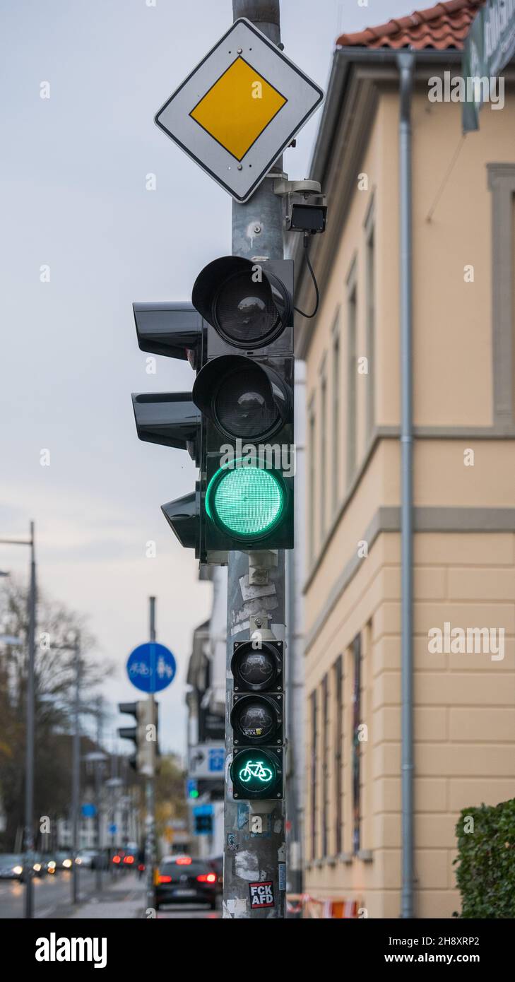 Vertical shot of double green glowing traffic light for cars and bikes ...