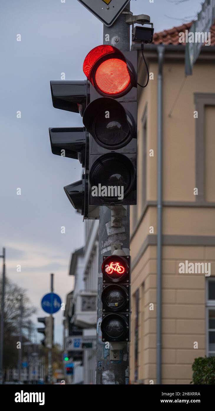 Vertical shot of double red glowing traffic light for cars and bikes ...