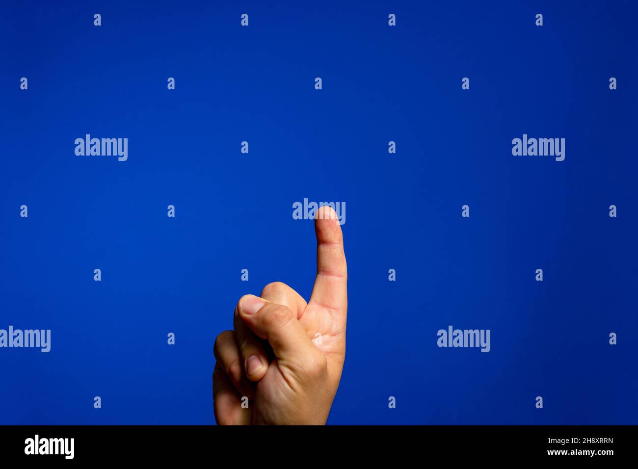 Index finger of a man's hand pointing up asking for a turn to do ...