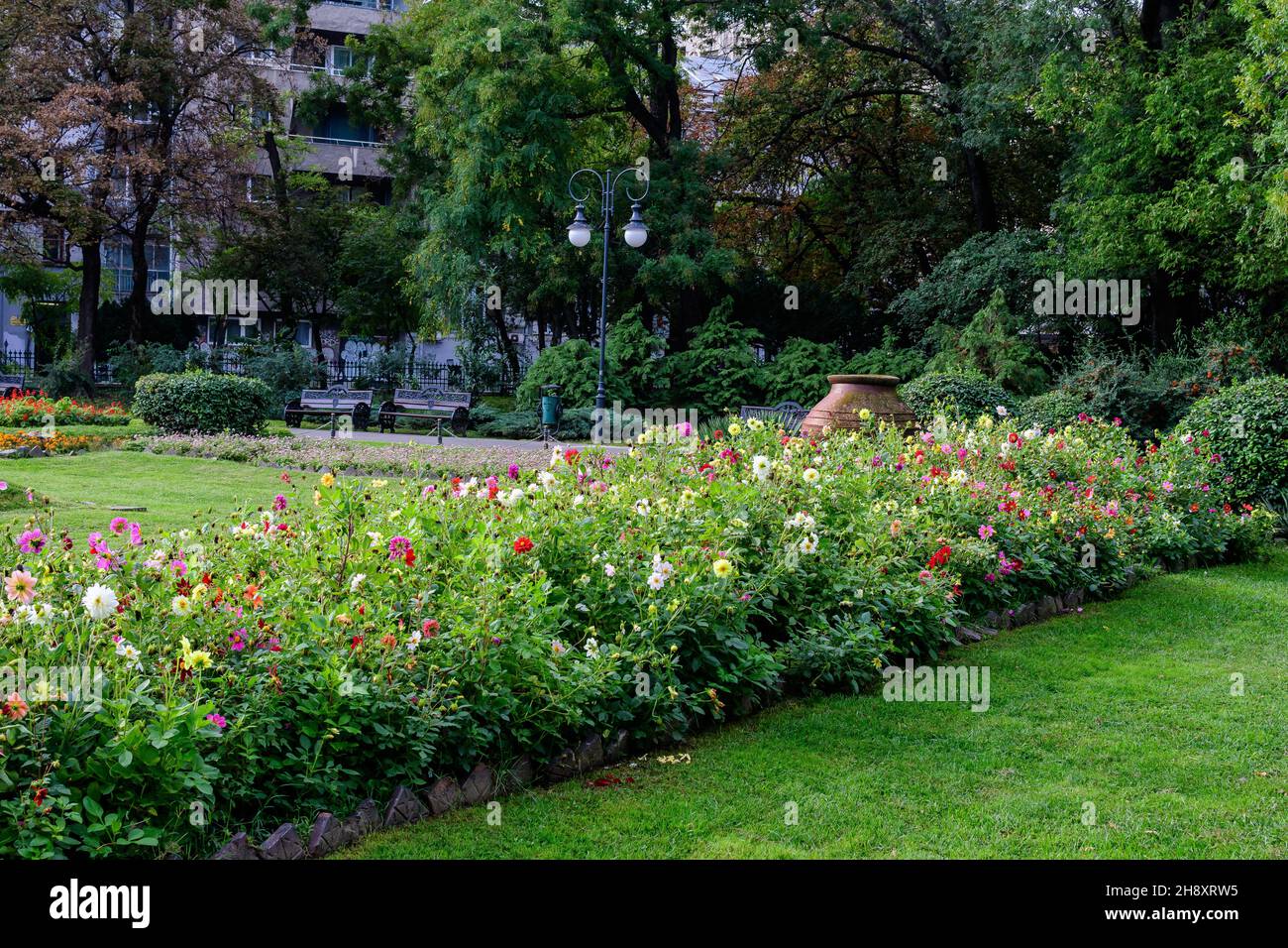 Landscape with the main entrance with vivid flowers and green plants ...