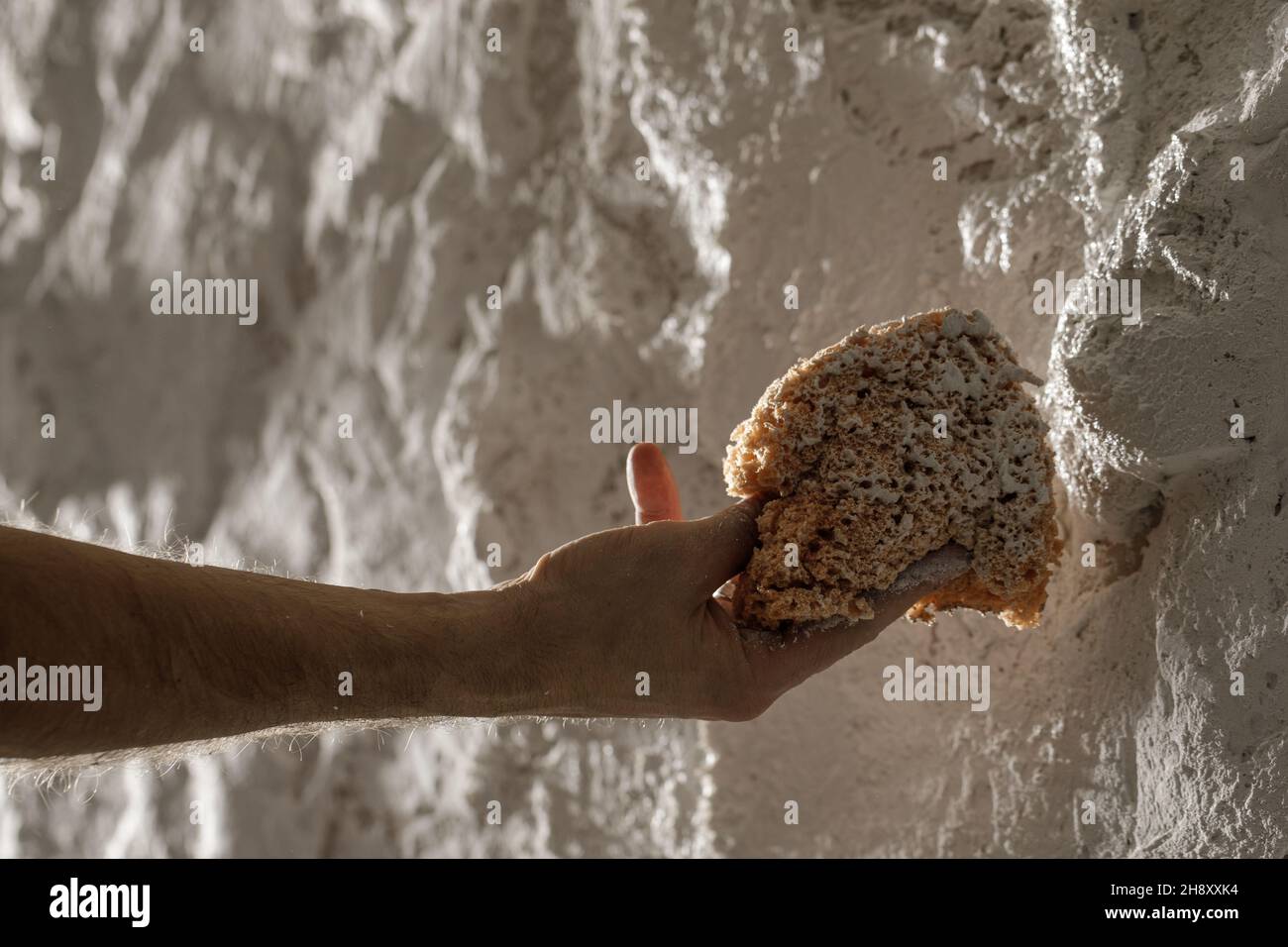 Process of creating white textured clay wall with cracks and ...