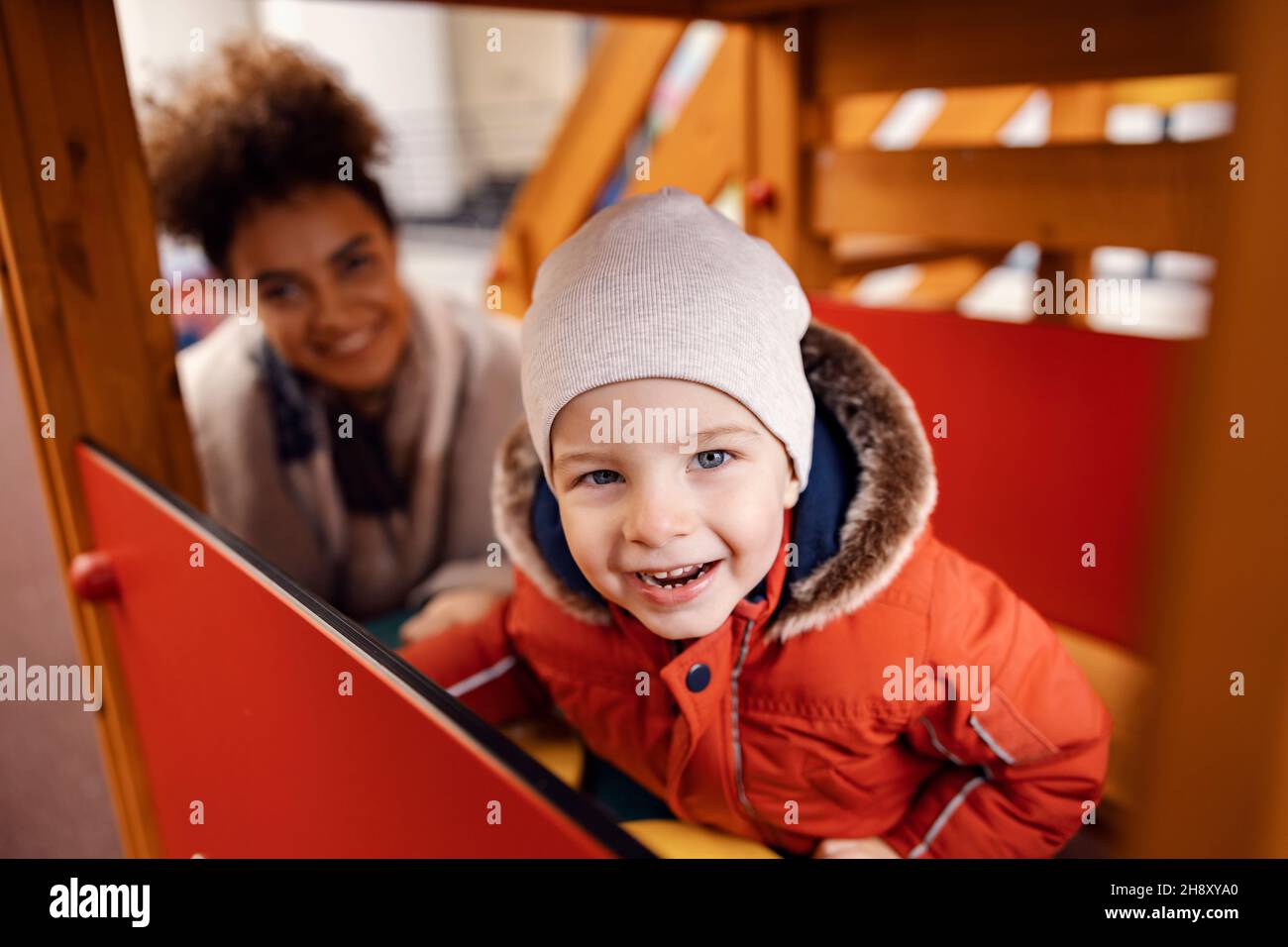 The happy face of a kindergarten child on a playground. A happy little ...