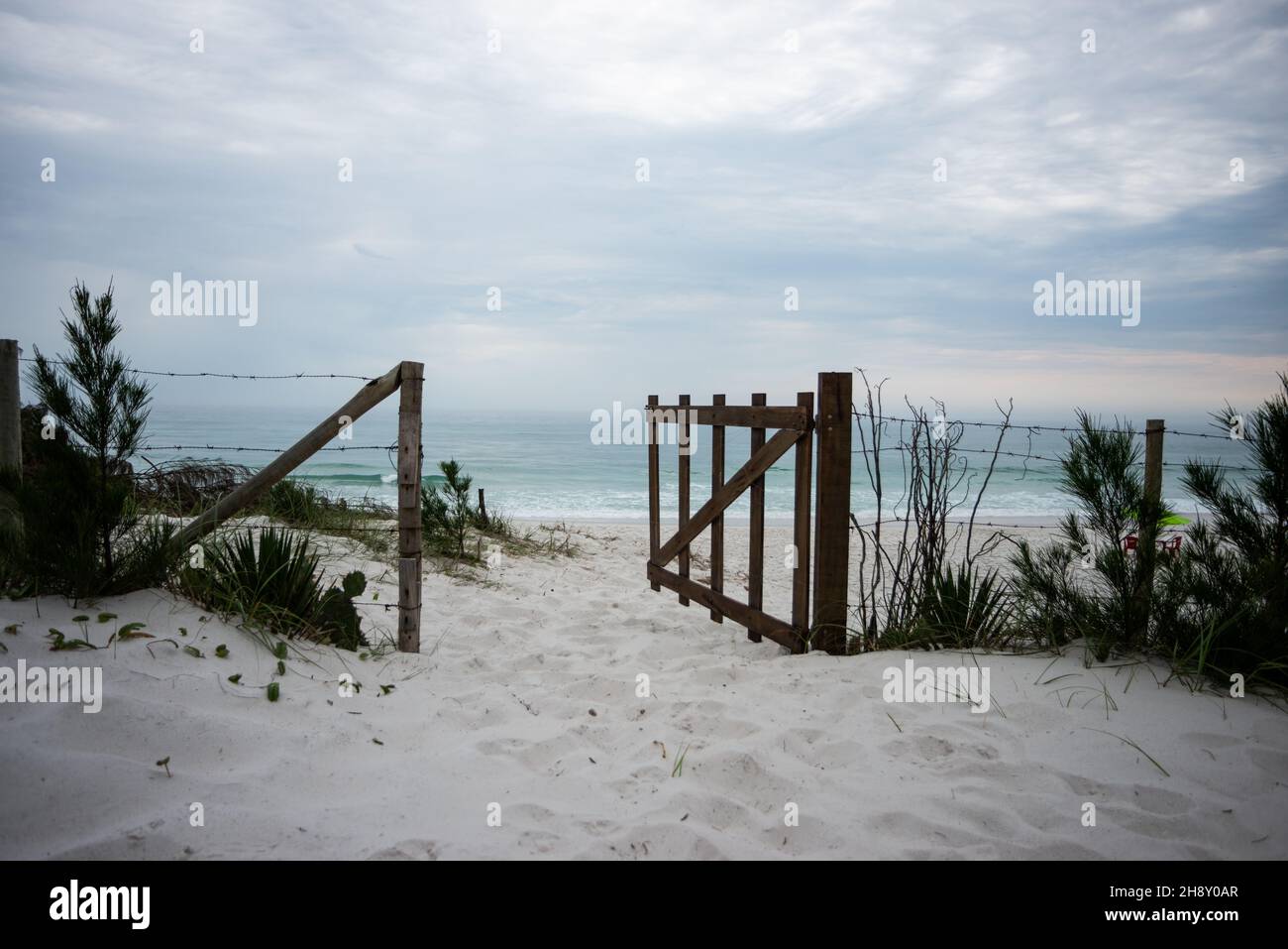 Open gate to a sea on the sandy beach Stock Photo - Alamy