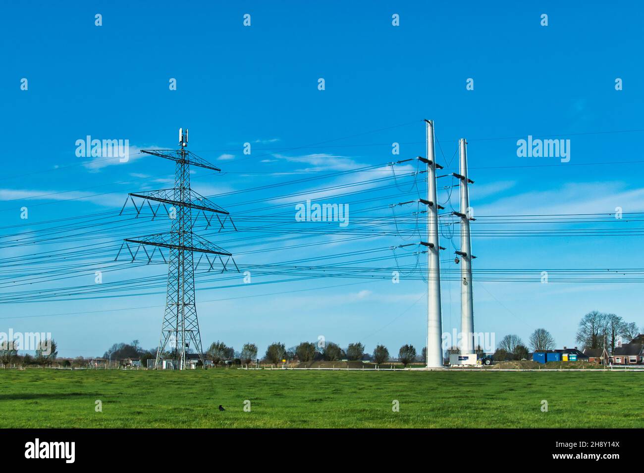 Traditional and modern electricity poles in the agricultural province ...