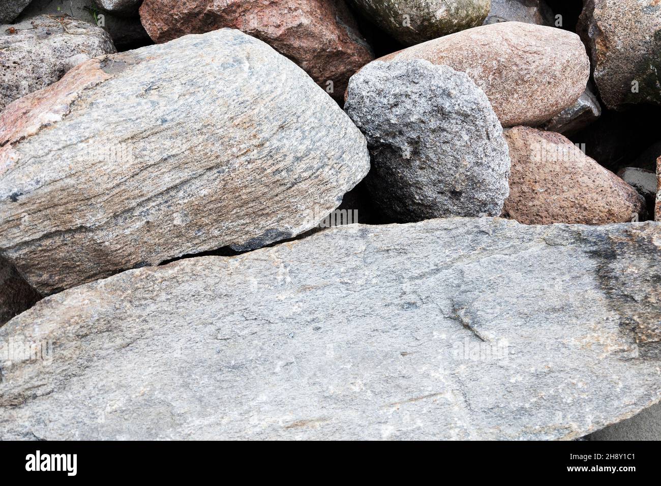 Rockfall on the road in the mountains. Stones of different sizes ...