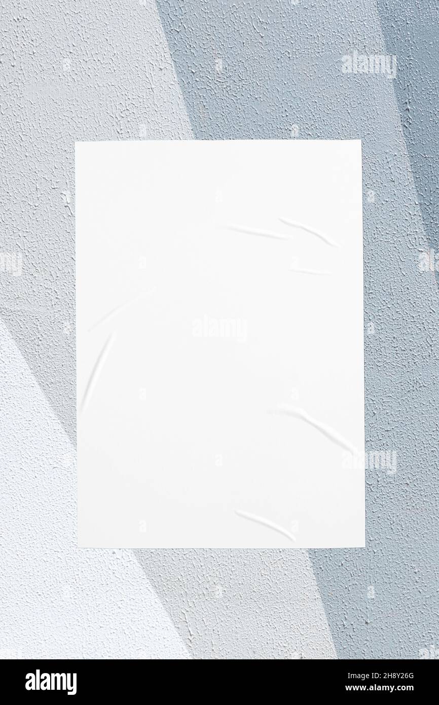 gray painted urban wall with wrinkled glued poster template Stock Photo ...