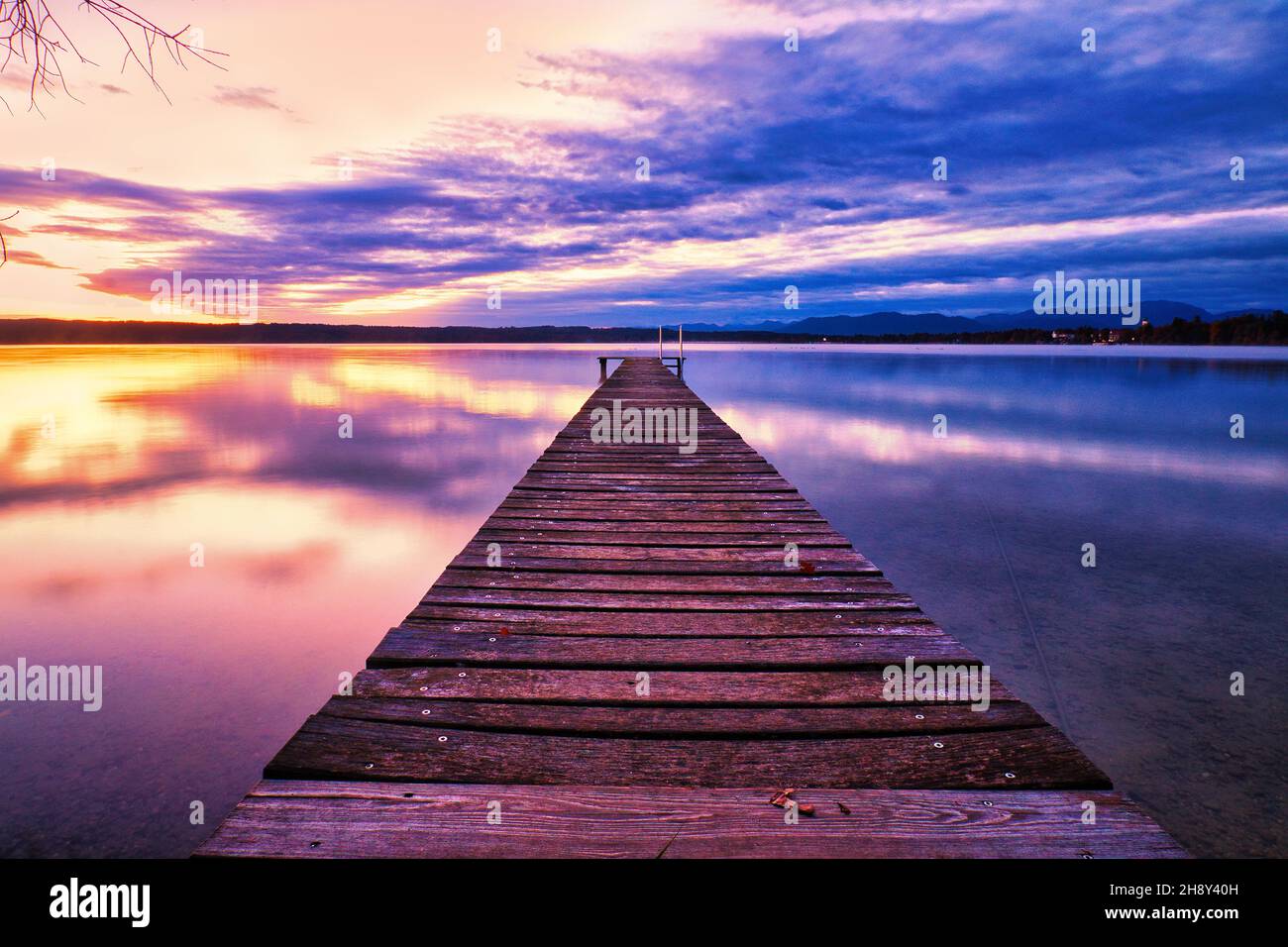 Wooden pier to the sea during beautiful sunset Stock Photo - Alamy