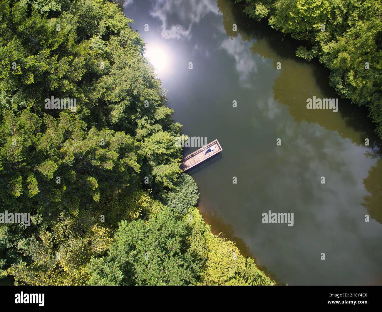 Top view of a wooden pier in a river flowing through the forest Stock ...
