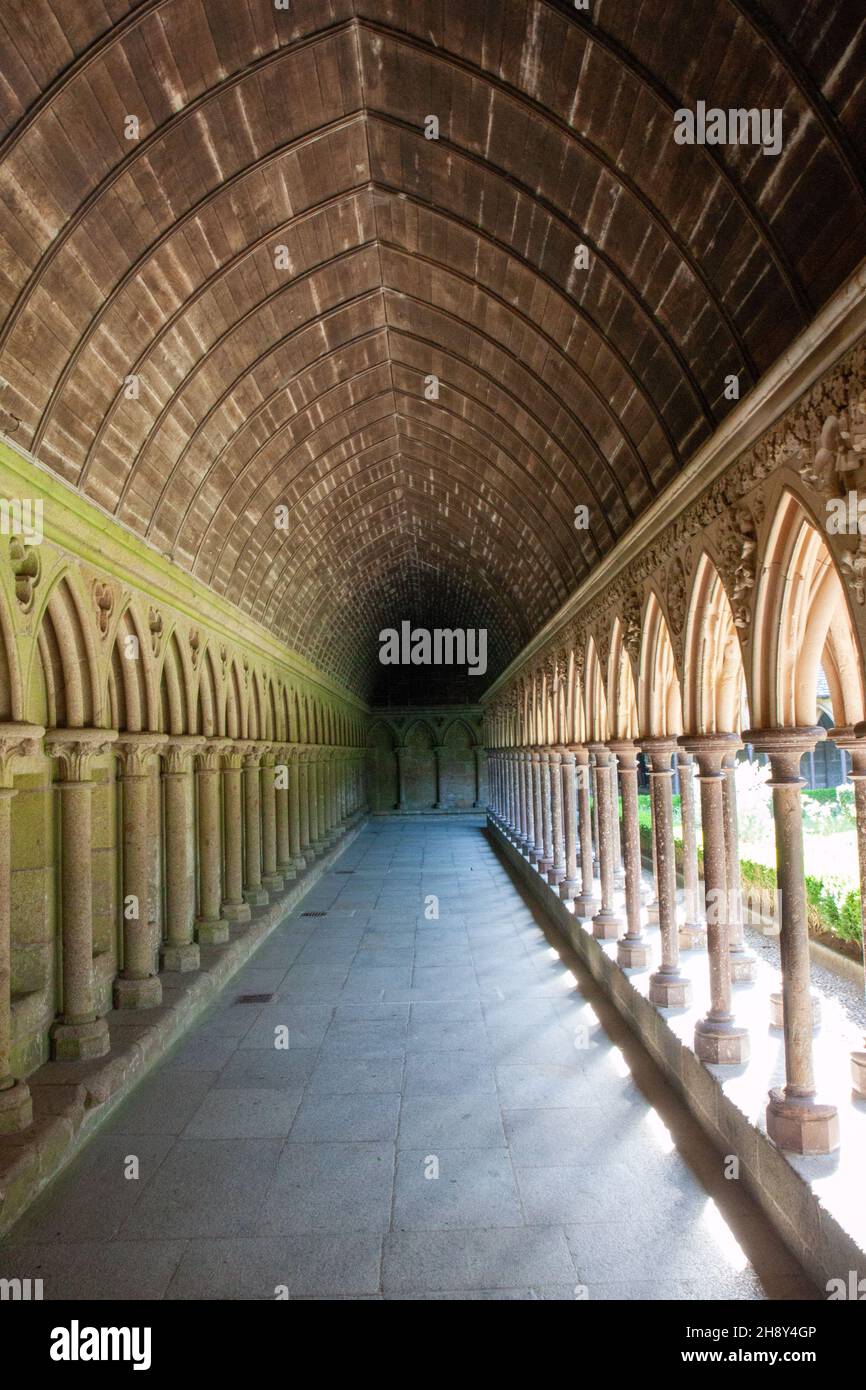 A walkway with gothic arch design looking out over a garden, in Mont ...