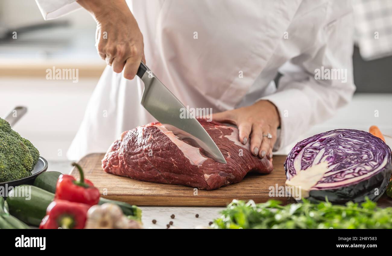 Female chef knife cuts beef hi-res stock photography and images - Alamy