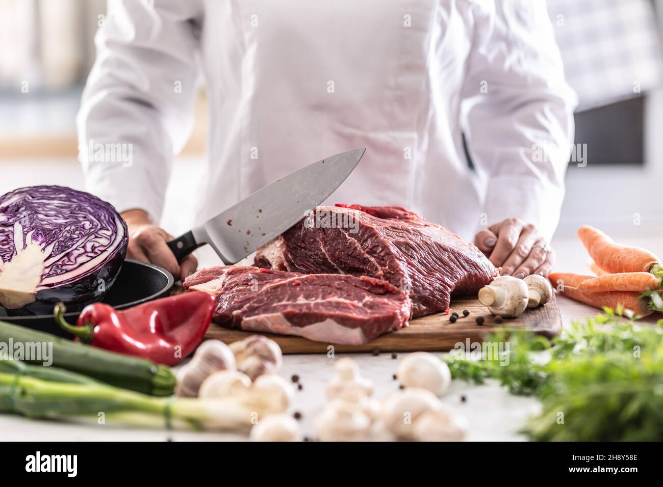 Sliced red meat cut by professional chef with red cabbage, carrotsm ...