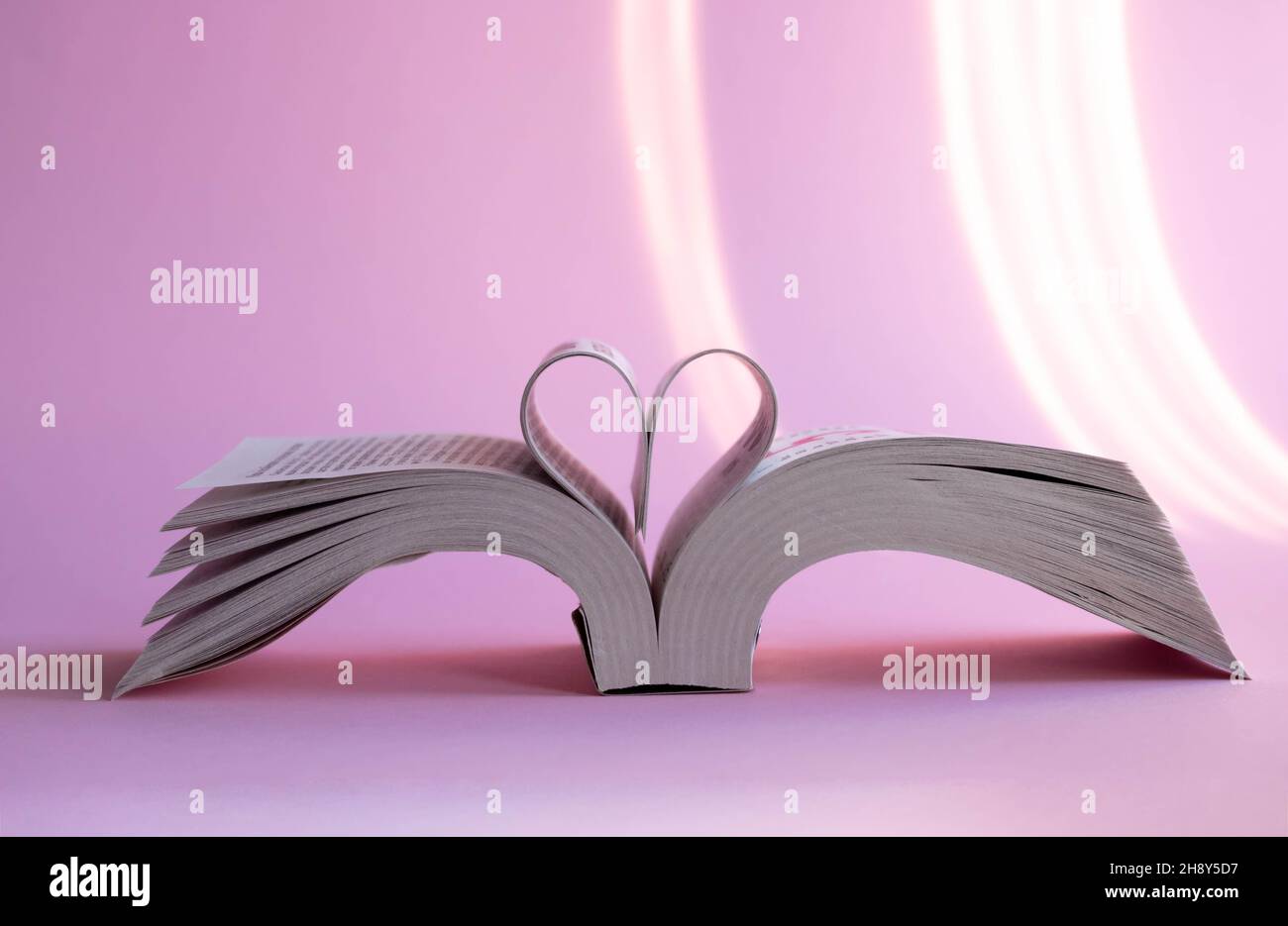 Tear-off calendar with pages folded in the shape of a heart on a pink ...