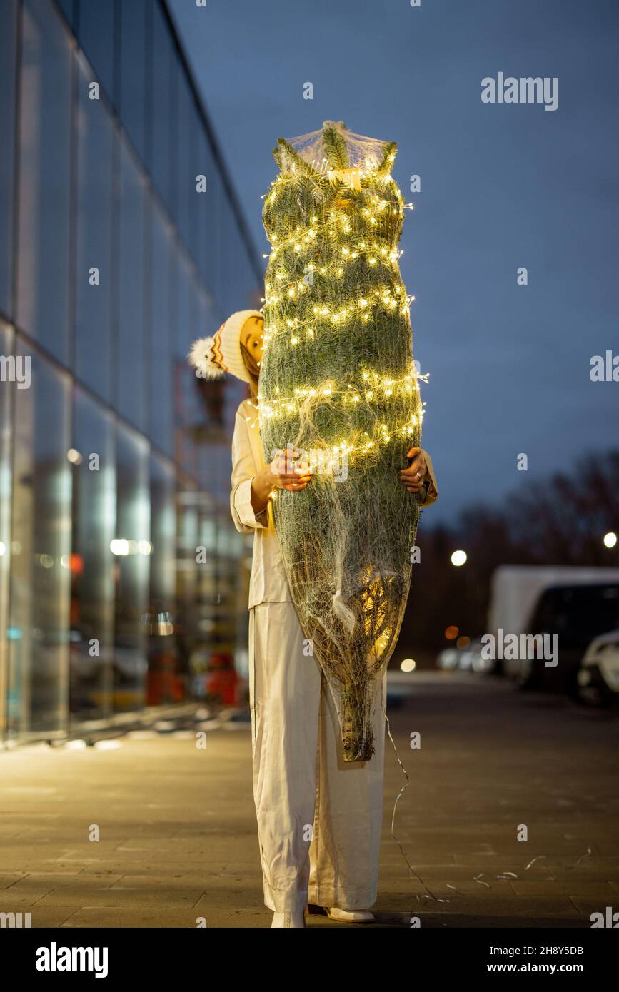 Happy woman walking christmas tree hi-res stock photography and images ...