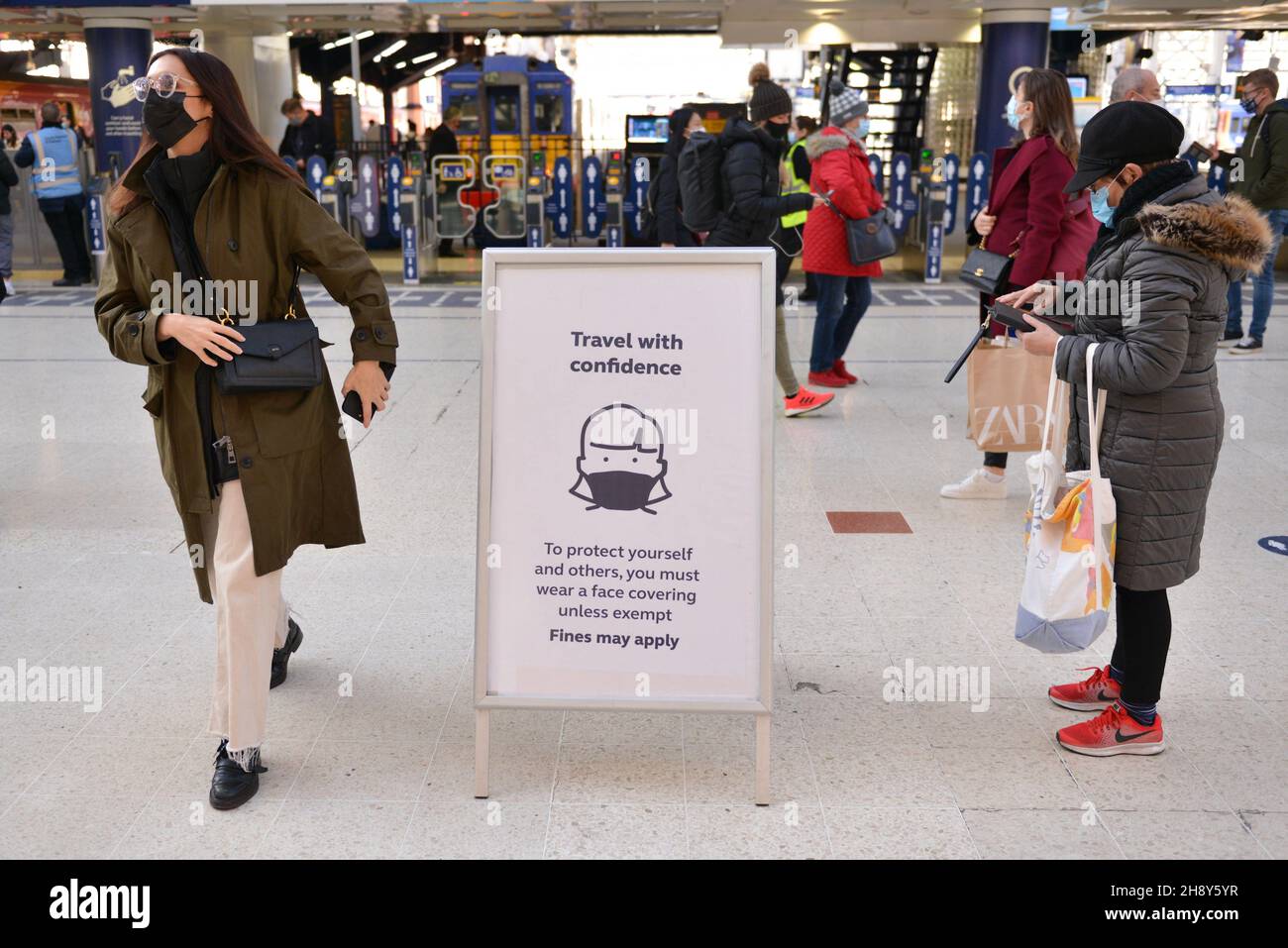 London, UK. 02nd Dec, 2021. A commuter seen walking past a Wear Face ...