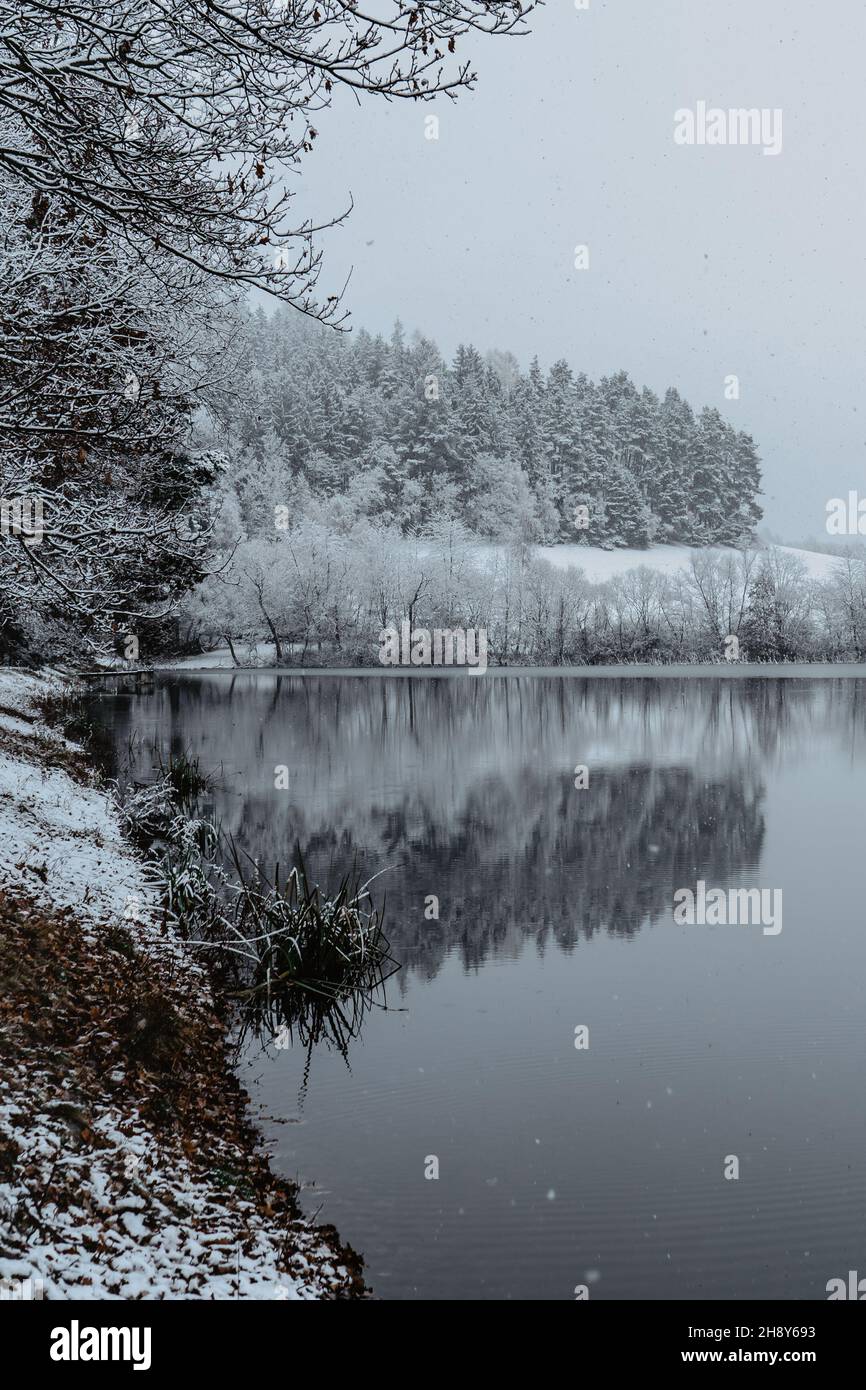 Lake covered with fresh snow.Winter pond,foggy cloudy landscape ...