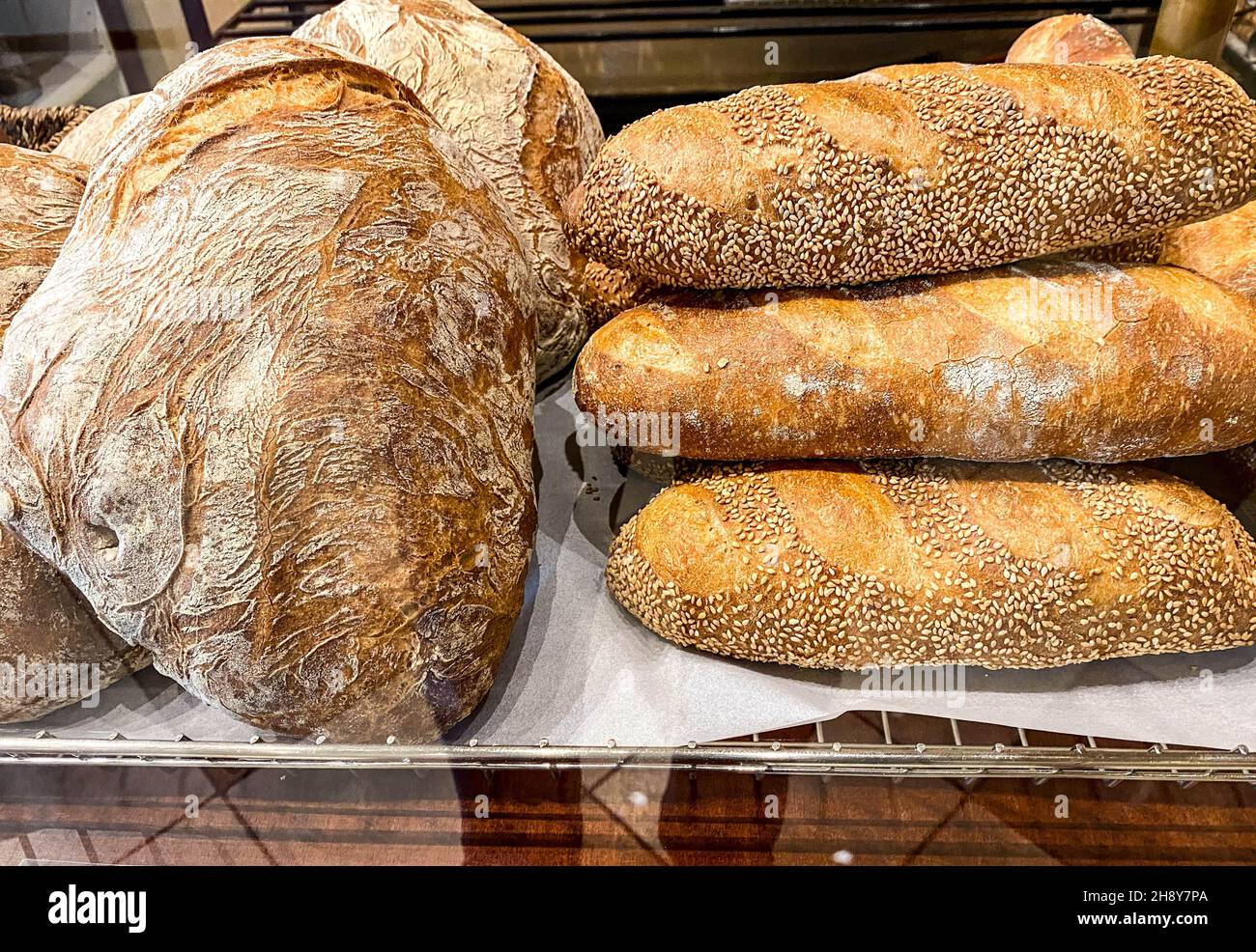 Fresh baked bread on display in bakery Stock Photo - Alamy