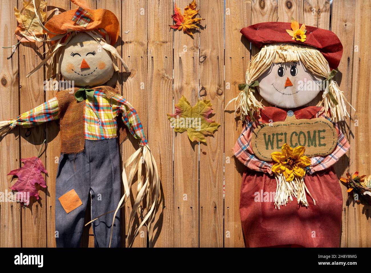 boy and girl autumn welcome scarecrow display Stock Photo - Alamy