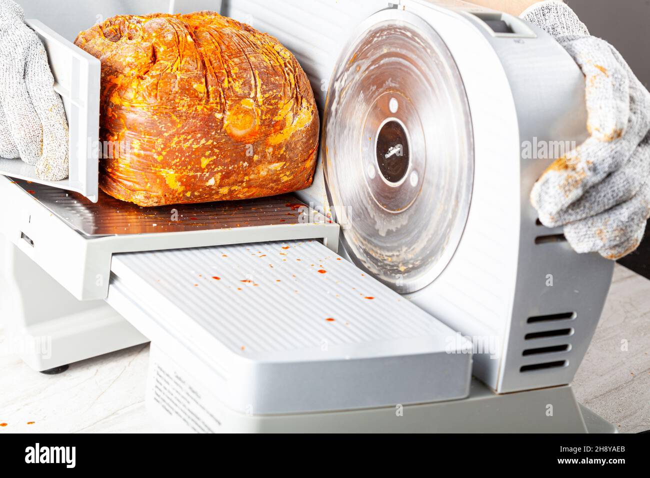 Close up isolated image showing a butcher or chef slicing a large ...
