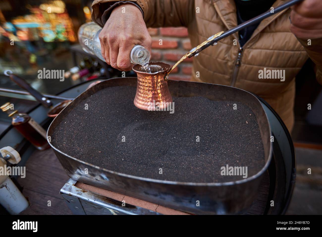 Aromatic coffee brewed in hot sand turkish coffee brewing in cezve ...