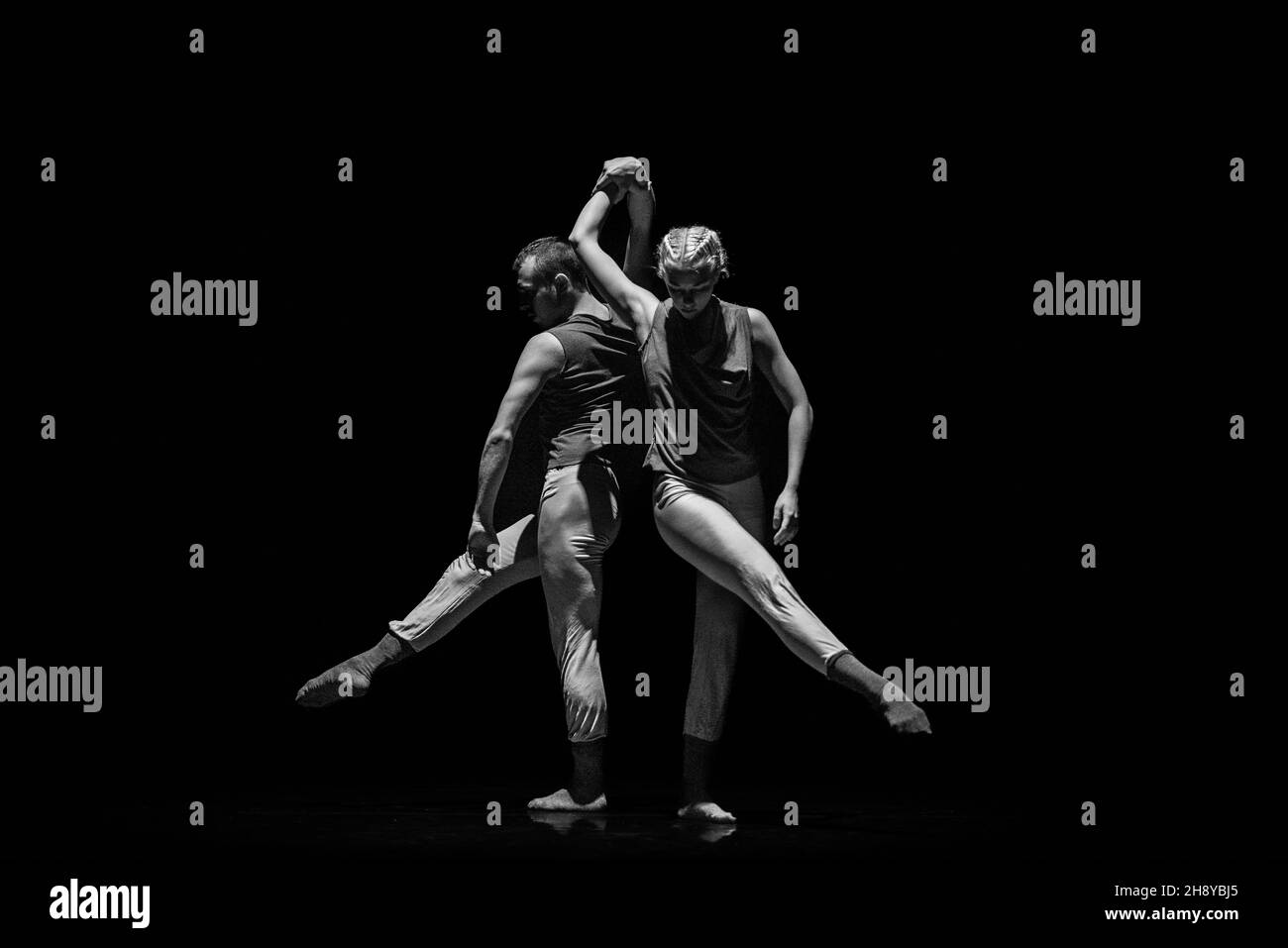 High contrast lighting of dancers on stage during dress rehearsal Stock ...