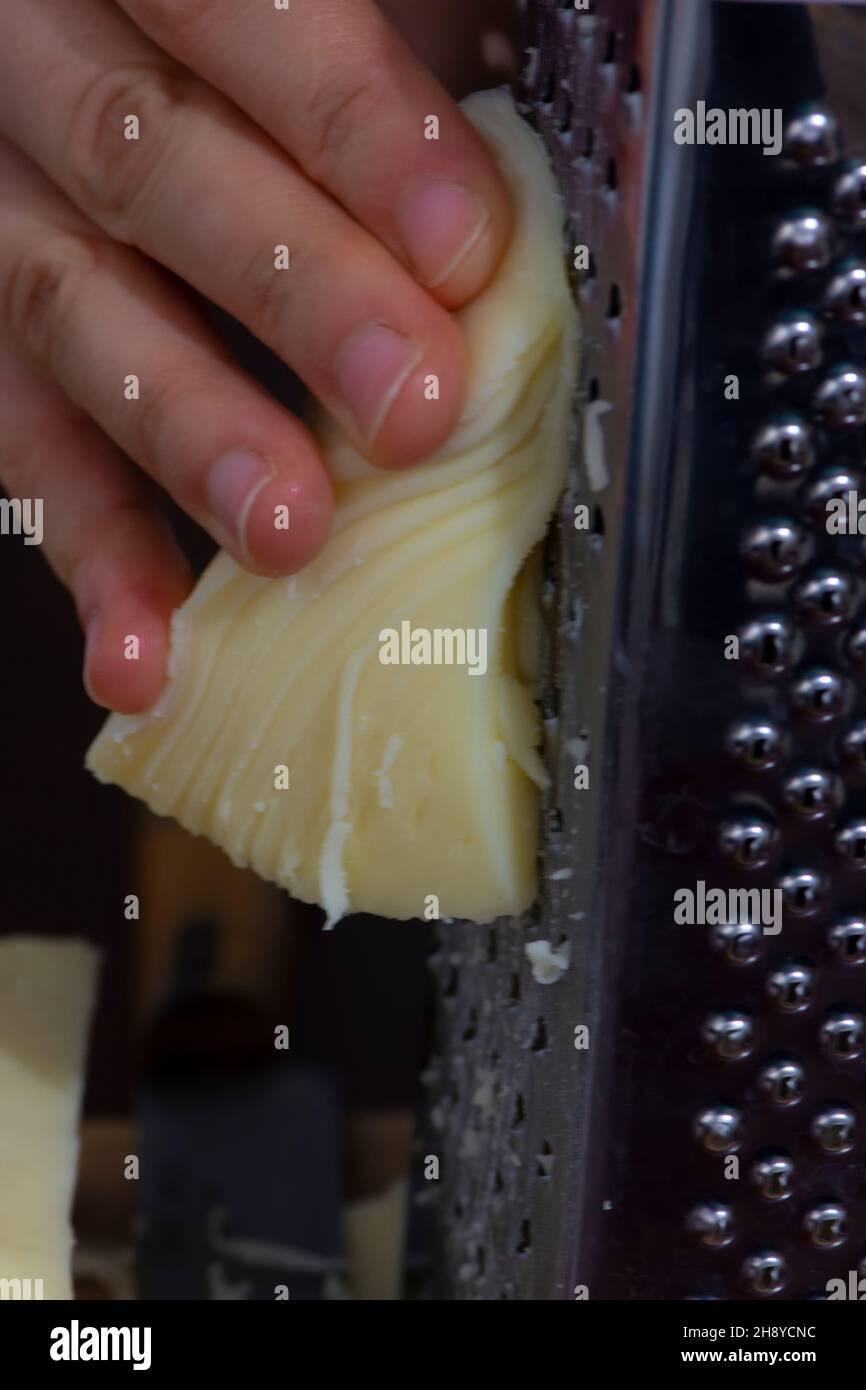 Grated cheddar cheese metal cheese grater hi-res stock photography and ...