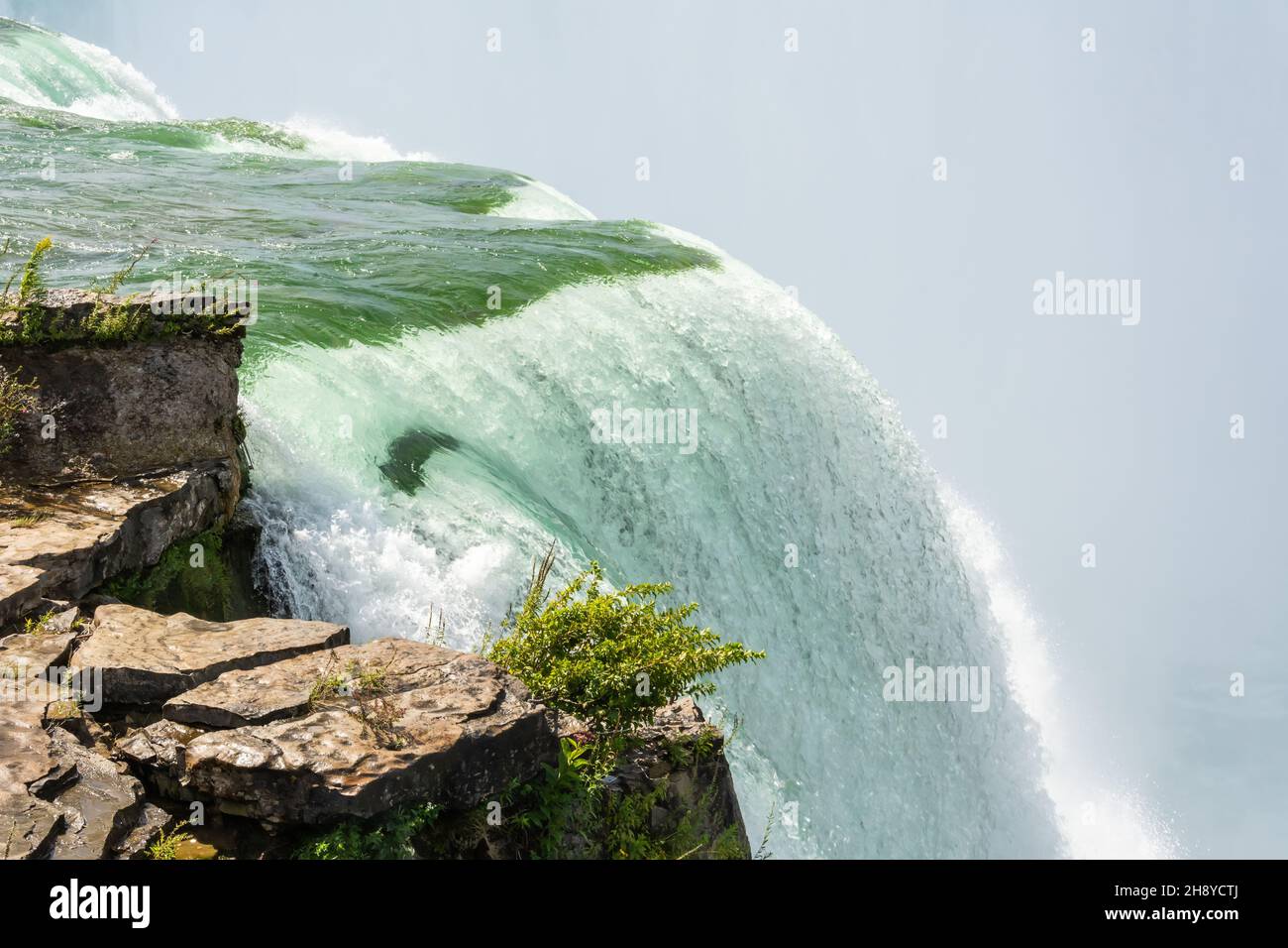 Water flowing over the edge of the Horseshoe Falls, the largest of the ...