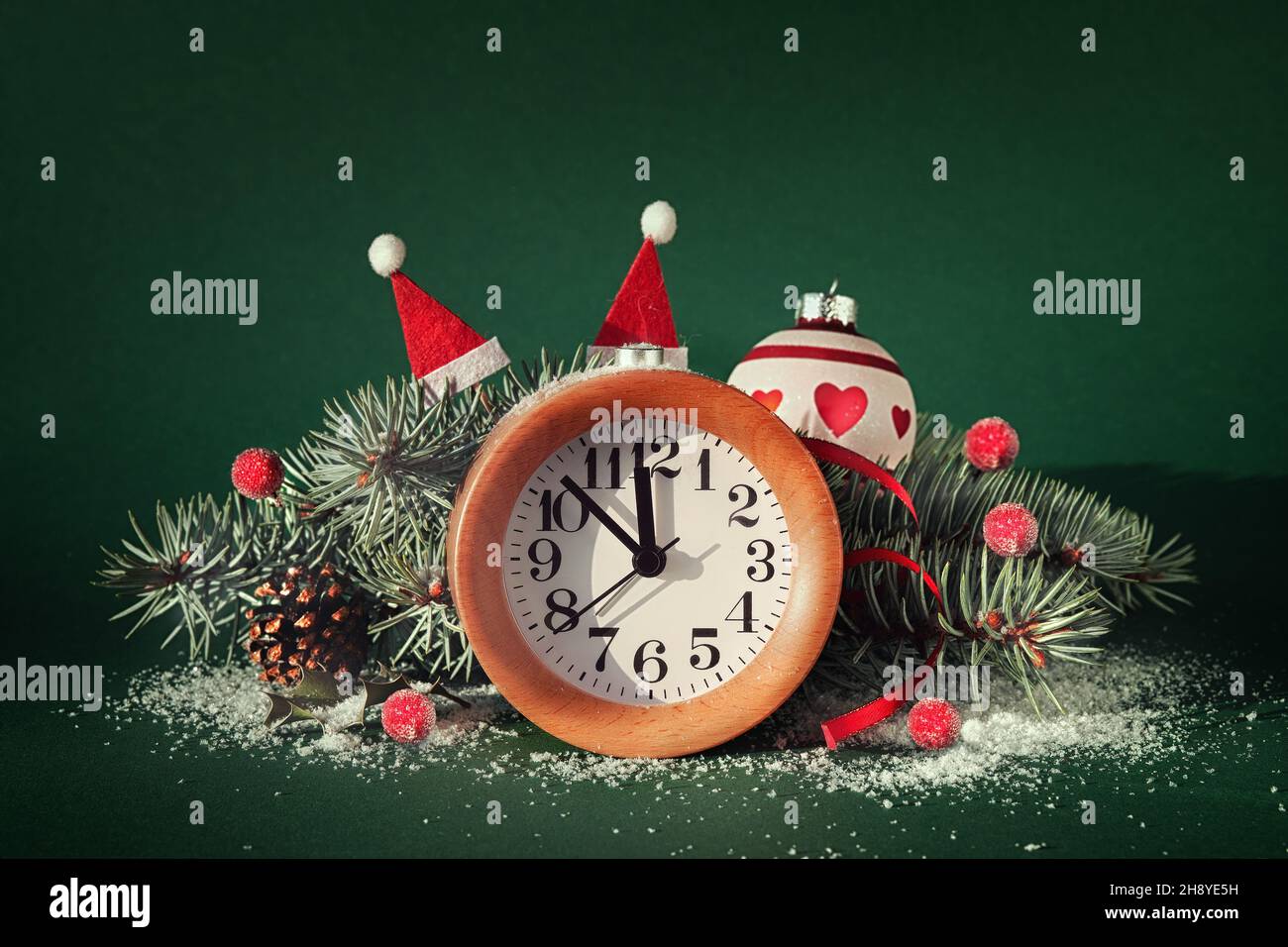 Countdown to midnight. Wood alarm clock with red baubles, Santa hats ...