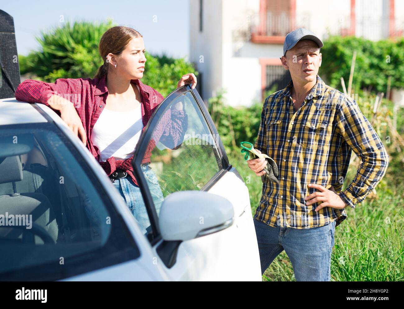 Farmers, having finished working, communicate standing by the car Stock ...