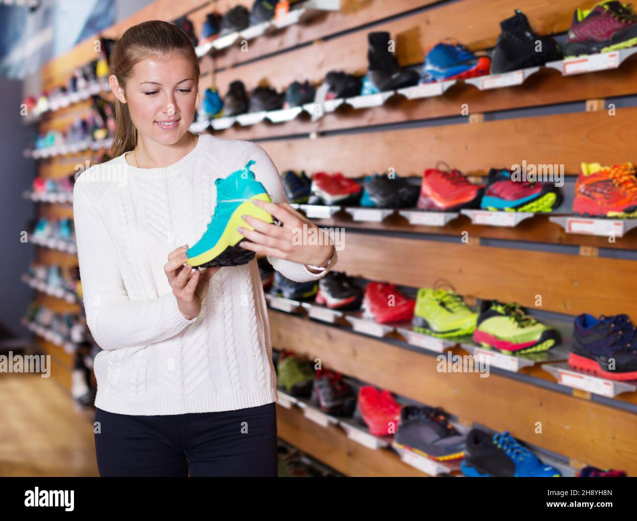 Girl chooses her clothes and shoes for training Stock Photo - Alamy