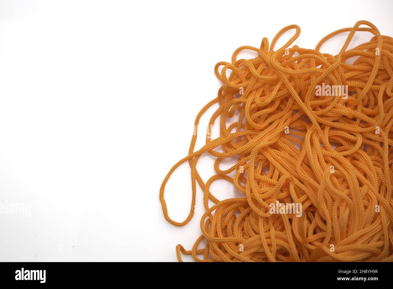 Top view of orange threads or rubber bands isolated on a white ...