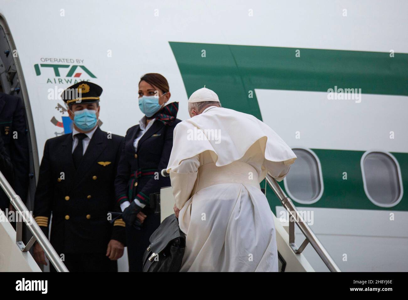 Pope Francis seen climbing the ladder of the plane, during the event ...