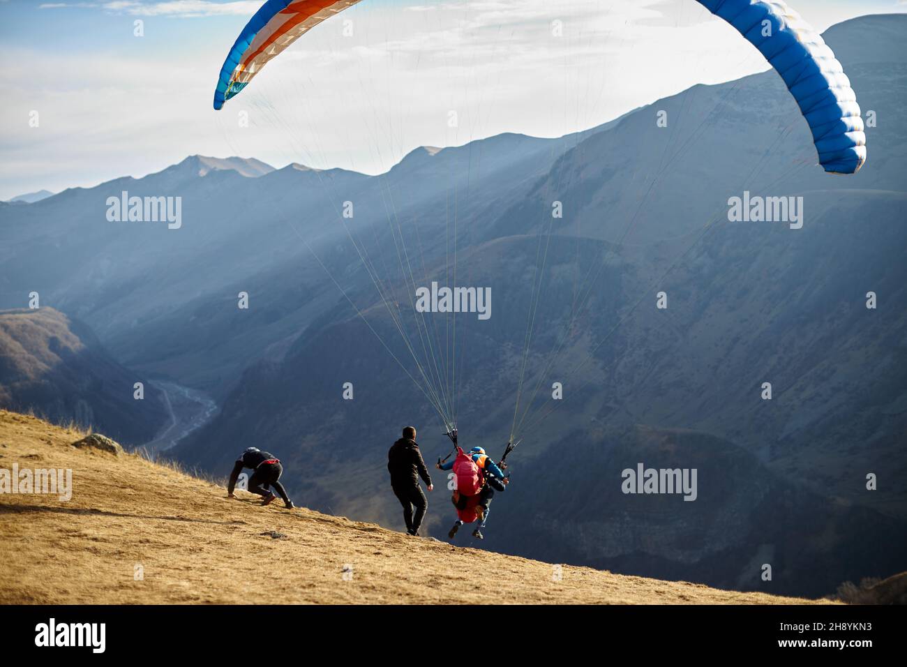Paraglide silhouette over mountain peaks. High quality photo Stock ...