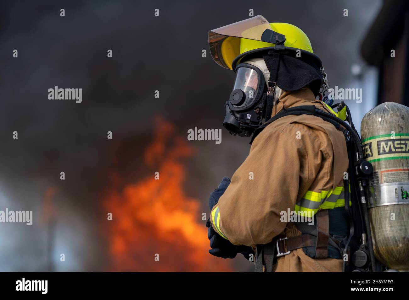 A U.S. Airman stands by to participate in a live aircraft fire ...