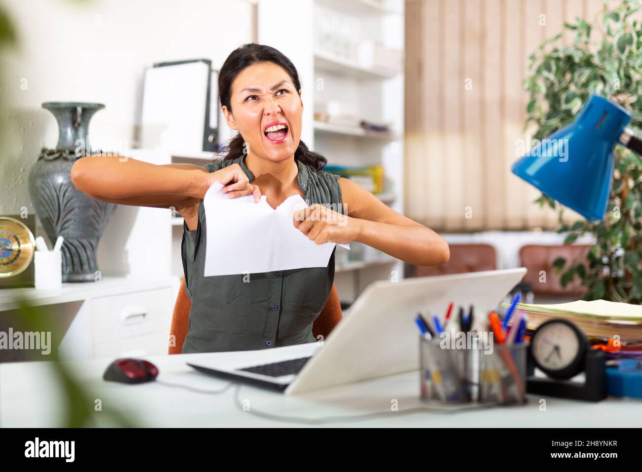 Upset asian female employee manager at working place Stock Photo - Alamy