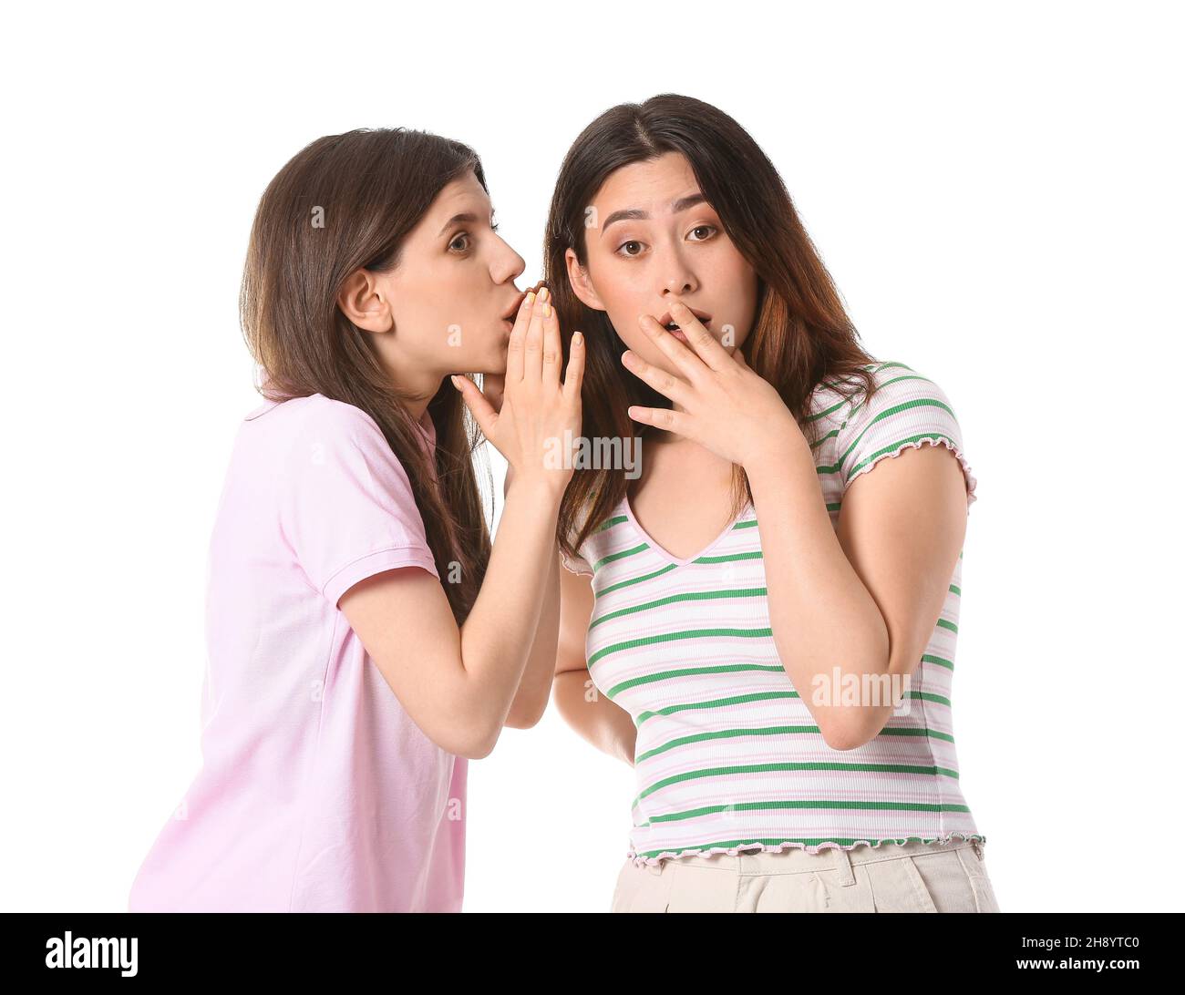 Young gossiping women on white background Stock Photo - Alamy
