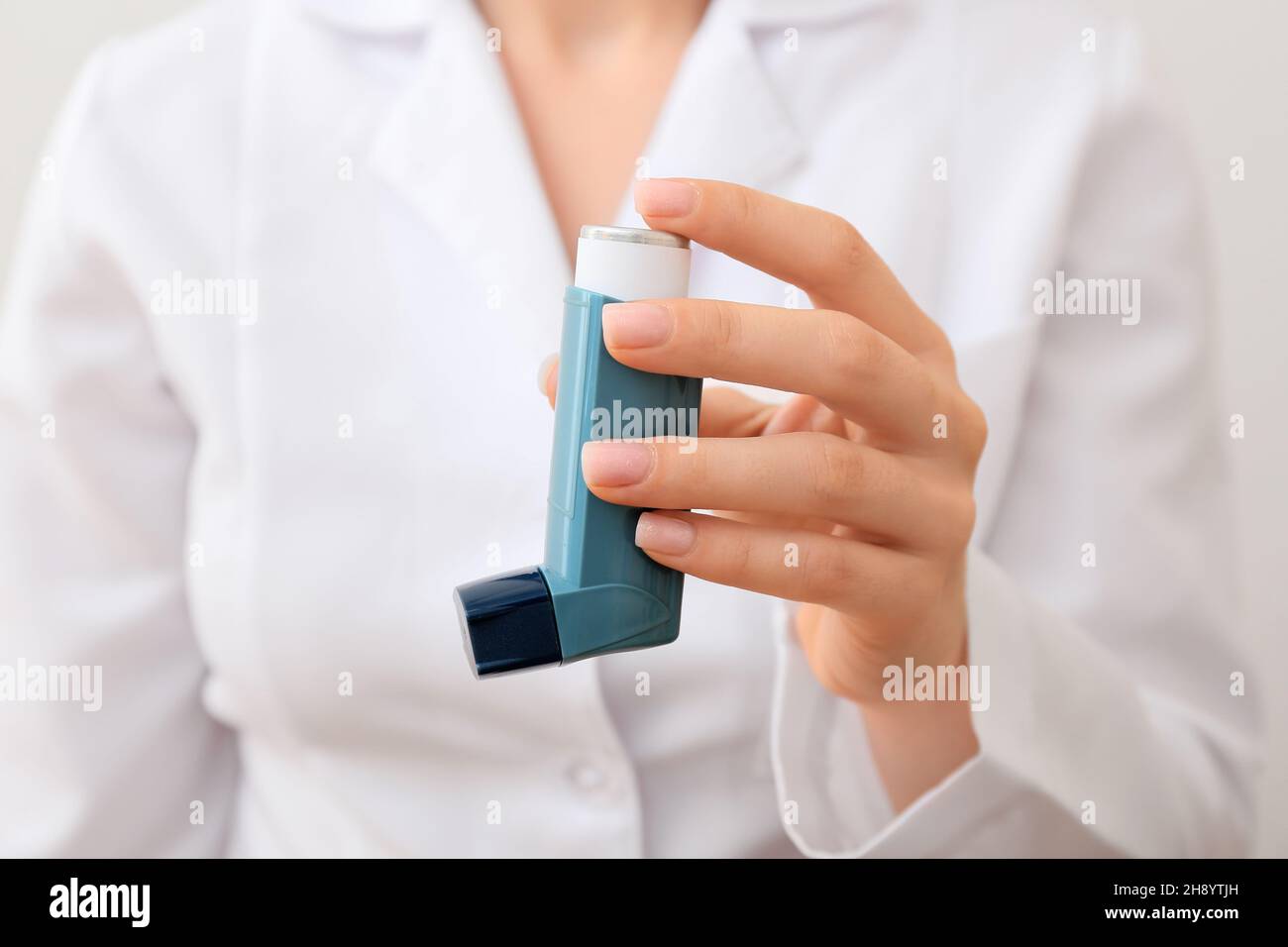 Female doctor with asthma inhaler, closeup Stock Photo - Alamy