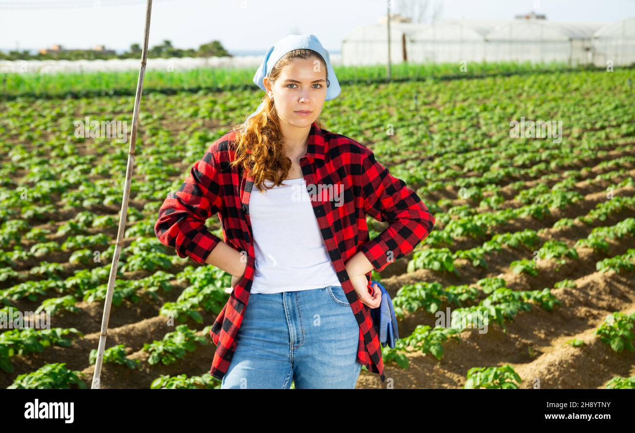 Confident girl farmer on vegetable farm field in spring Stock Photo - Alamy