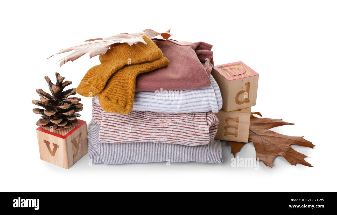 Stack of baby clothes, toys and natural decor on white background Stock ...